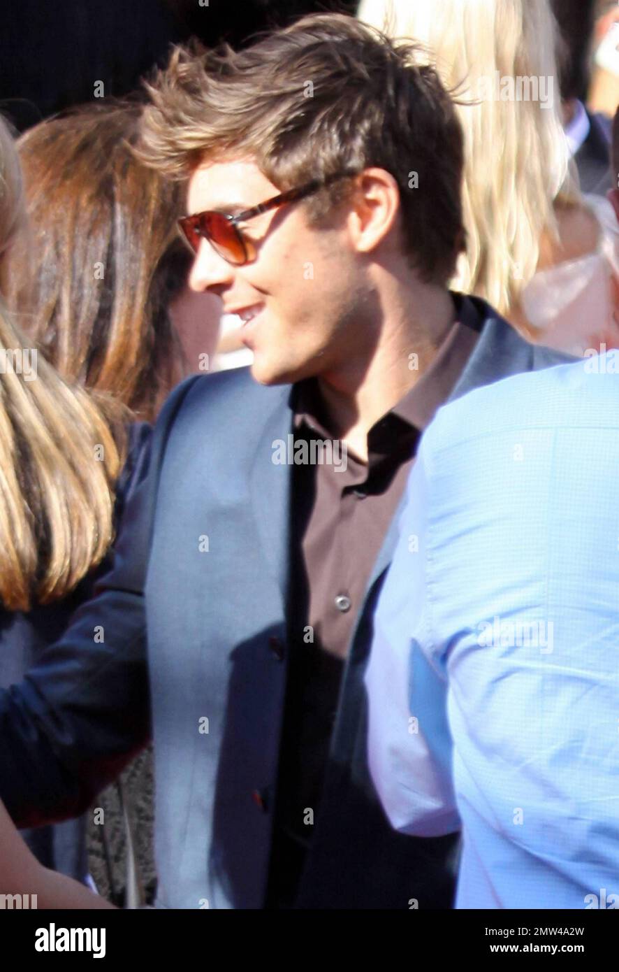 Actor Zac Efron hugs a female friend before he heads down the red ...