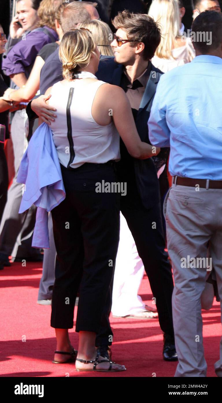 Actor Zac Efron hugs a female friend before he heads down the red ...