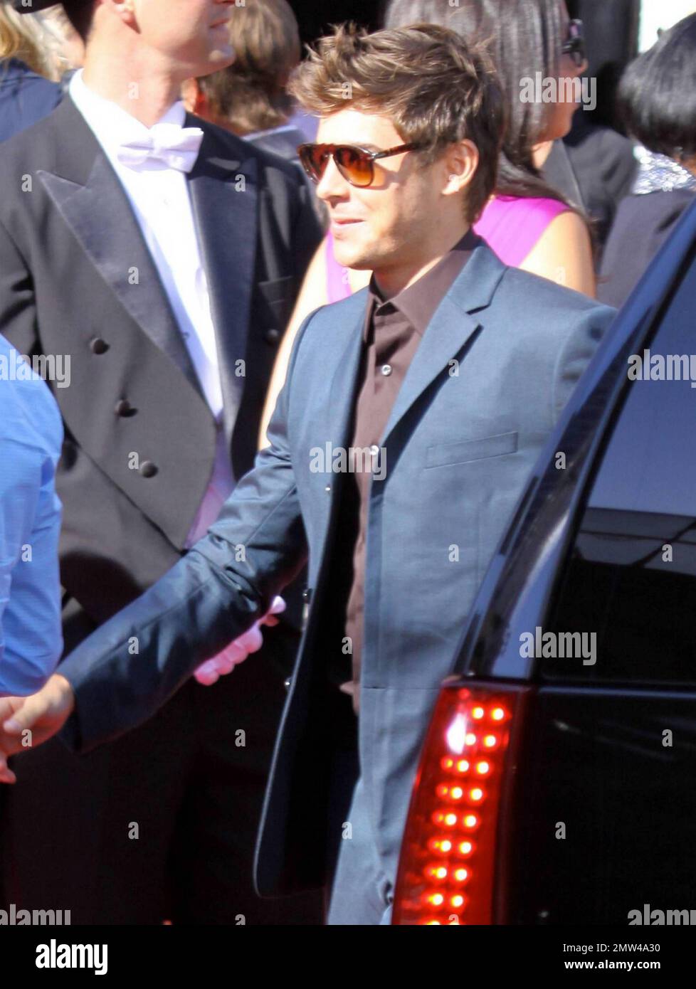 Actor Zac Efron hugs a female friend before he heads down the red ...