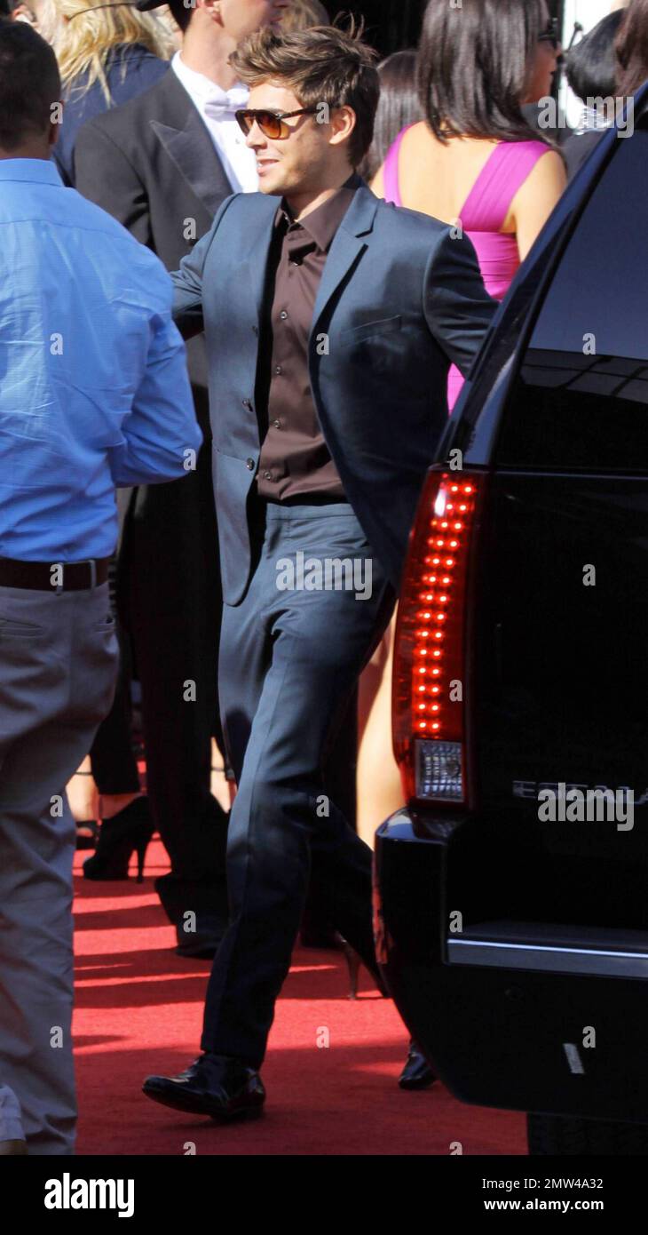 Actor Zac Efron hugs a female friend before he heads down the red ...