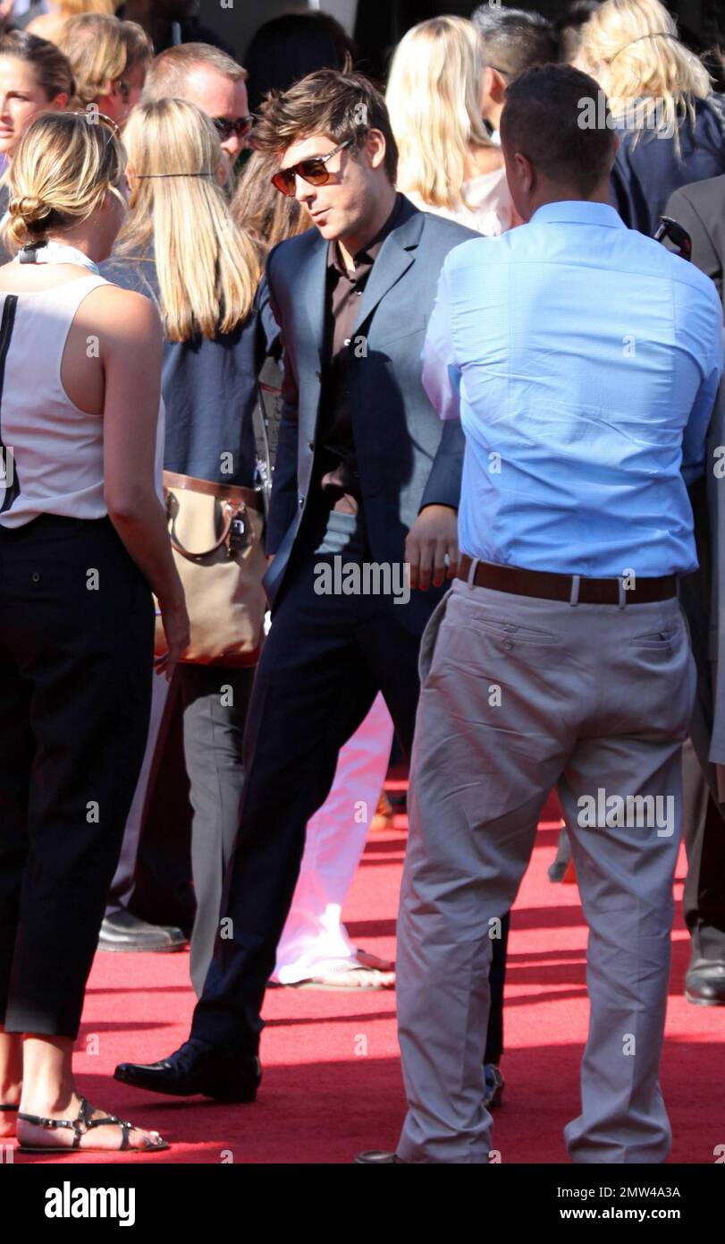 Actor Zac Efron hugs a female friend before he heads down the red ...