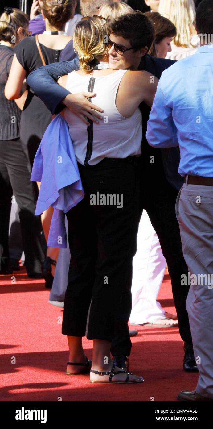 Actor Zac Efron hugs a female friend before he heads down the red ...