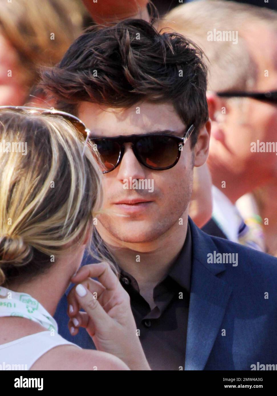 Actor Zac Efron hugs a female friend before he heads down the red ...