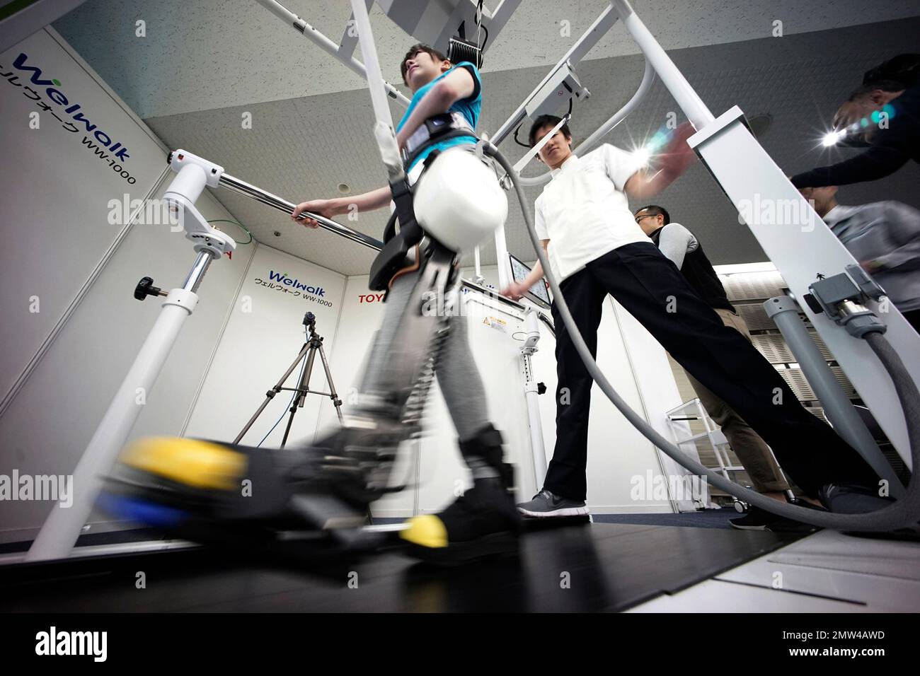 A model demonstrates the Welwalk WW-1000, a wearable robotic leg brace ...