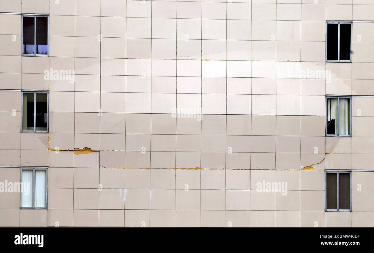 The cracked and buckling facade of a building is shown after occupants ...