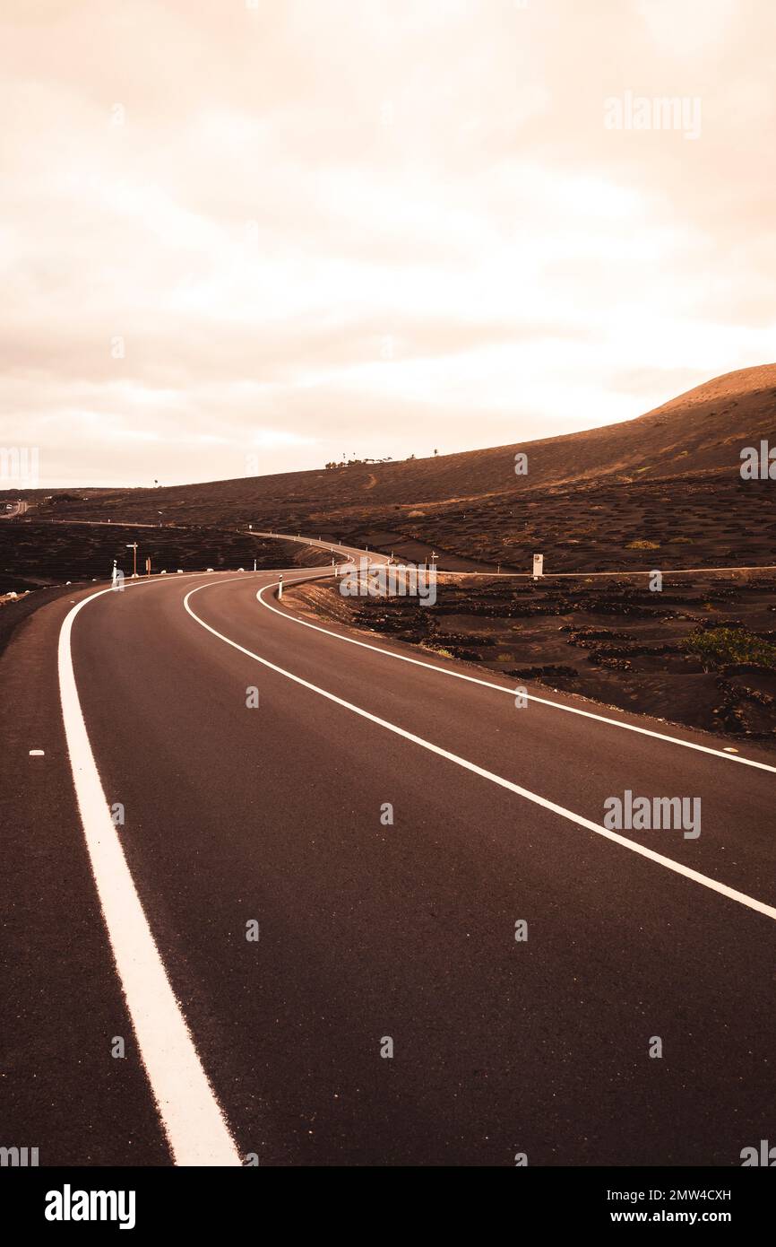 A vertical shot of the narrow highway between the hills and mountains ...
