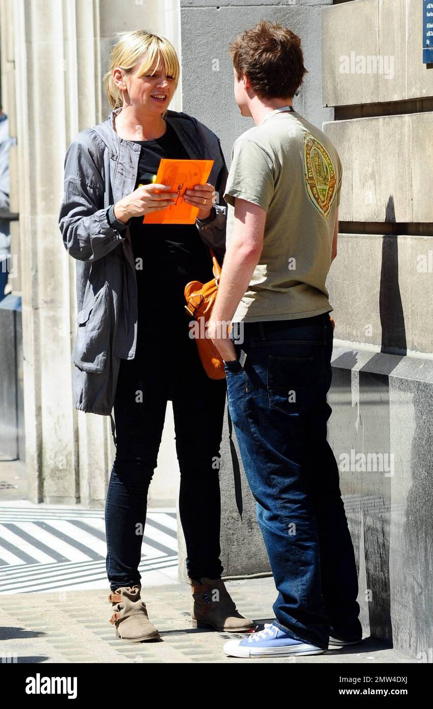 Radio 2 DJ Zoe Ball chats with a friend as she holds a large orange ...