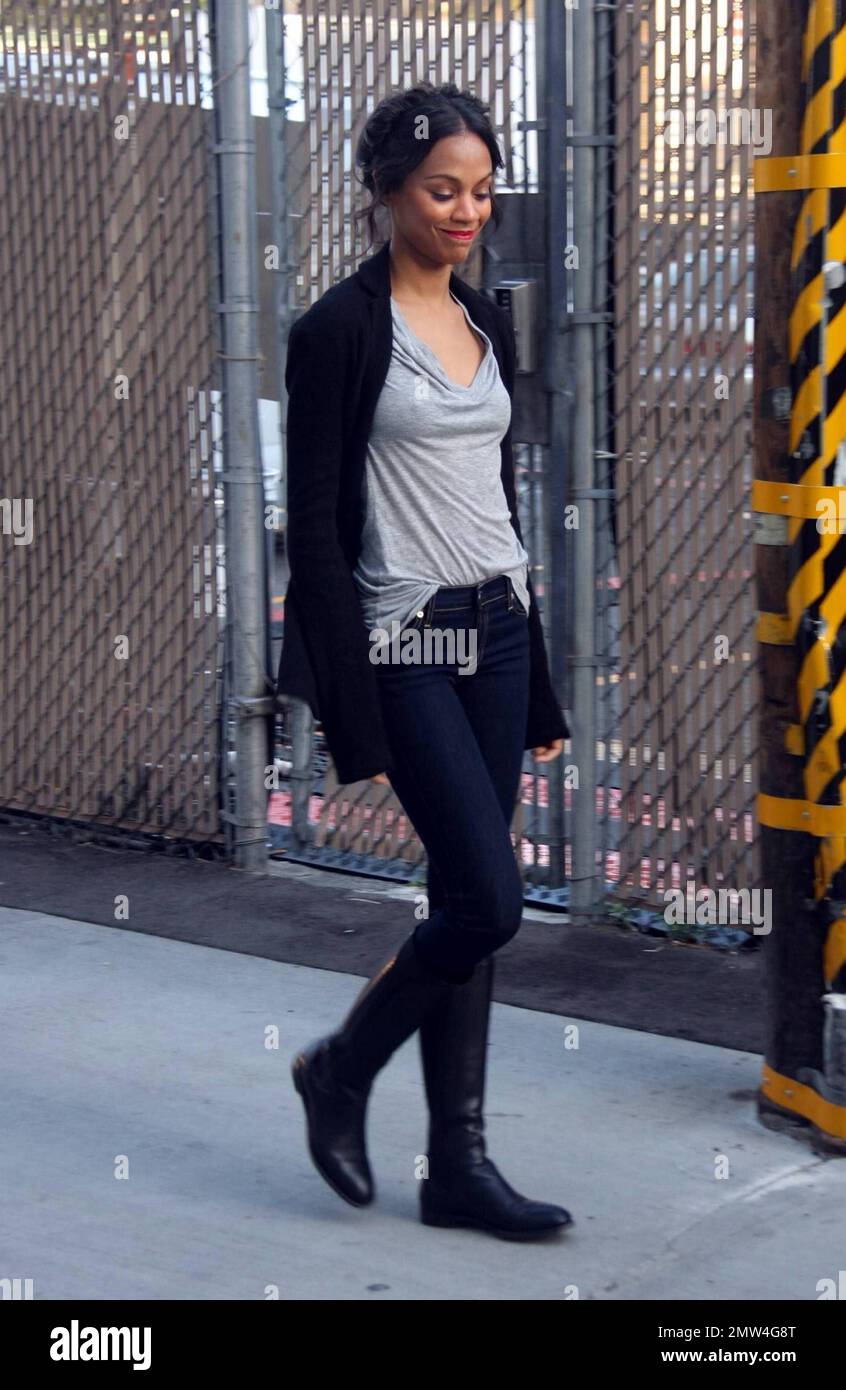 A casually dressed Zoe Saldana signs autographs for fans as she arrives ...