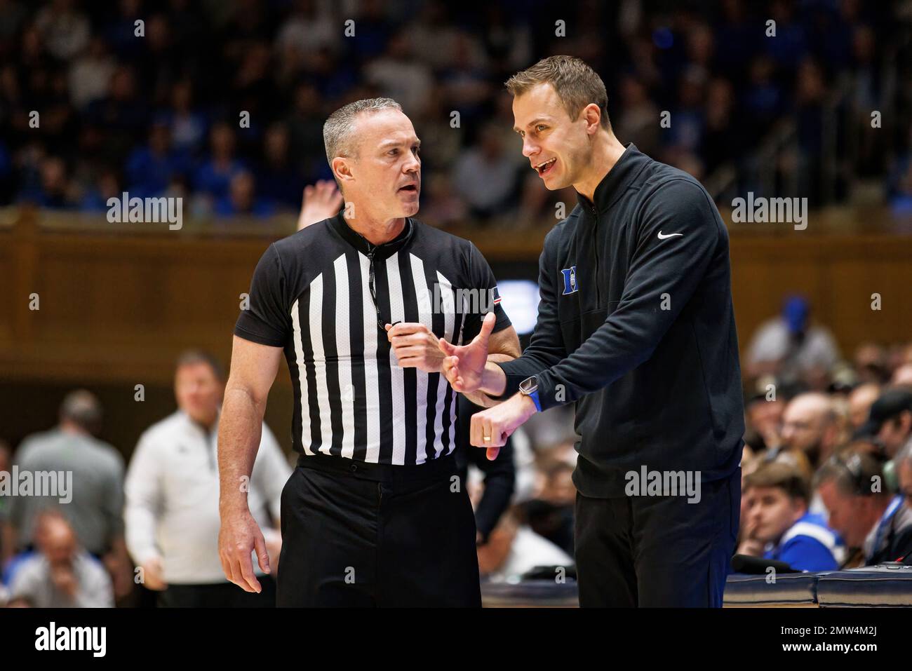 Duke head coach Jon Scheyer, right, speaks to official Ron Groover ...