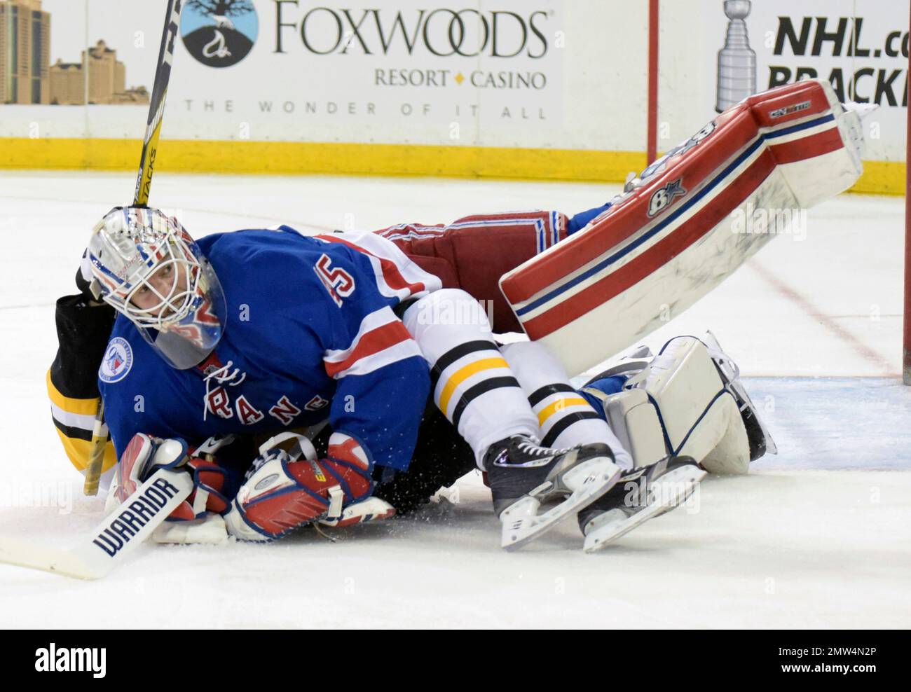 New York Rangers goalie Magnus Hellberg (45) gets tangled with by ...