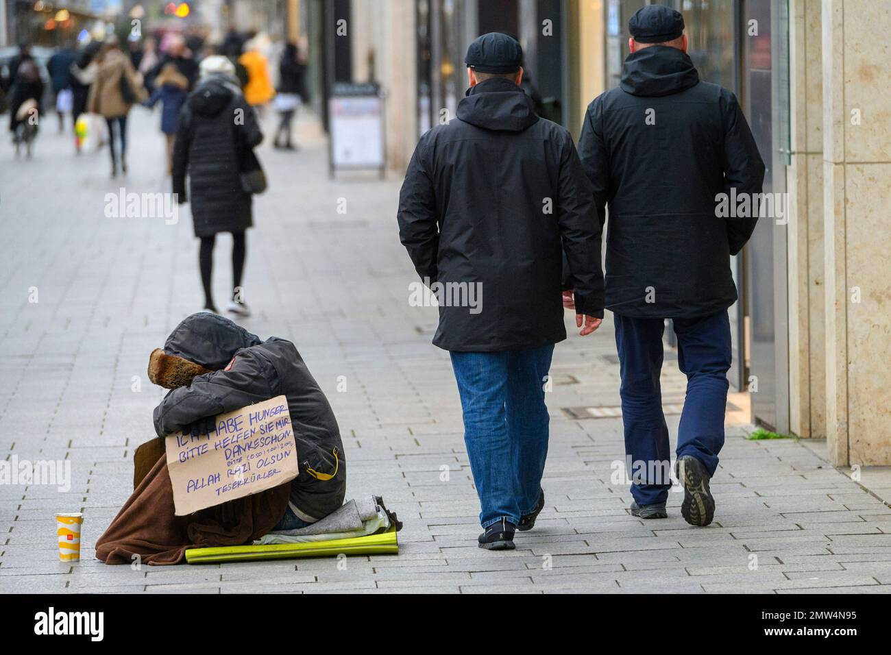 Dusseldorf, Deutschland. 01st Feb, 2023. A poor person begs sitting on ...