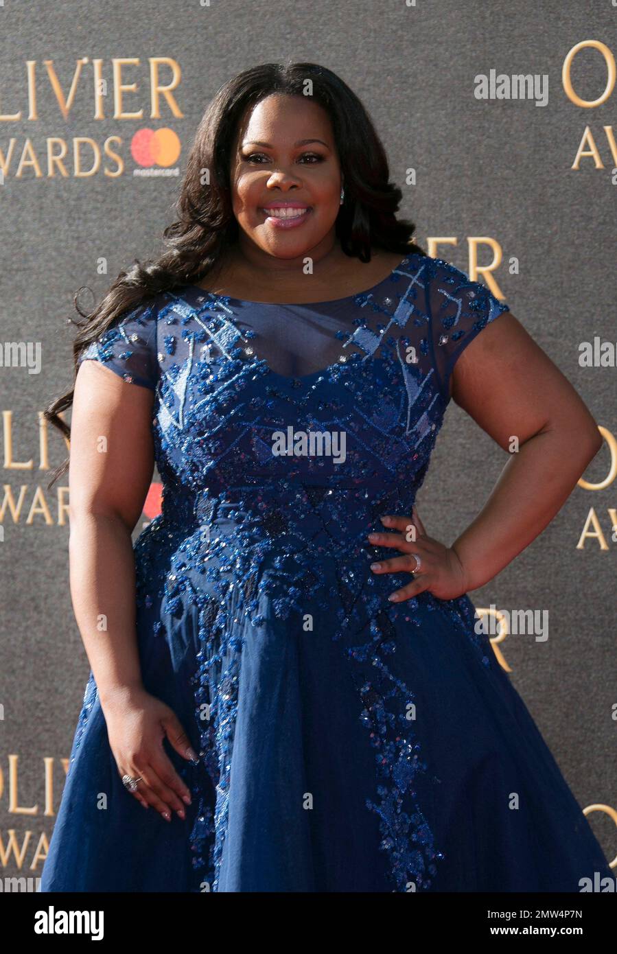 Amber Riley poses for photographers as they arrive for the Olivier ...