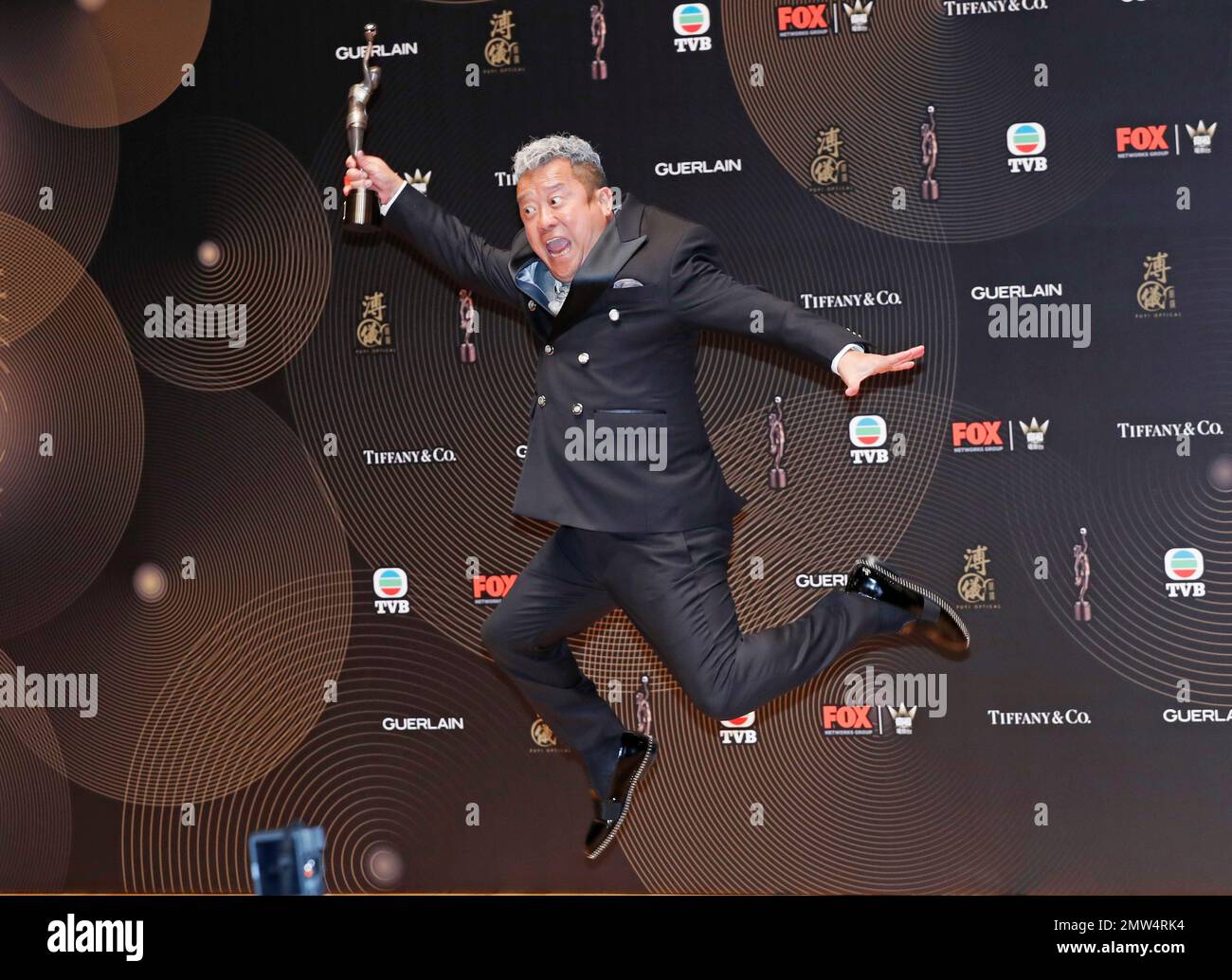 Hong Kong actor Eric Tsang poses after winning the Best Supporting ...