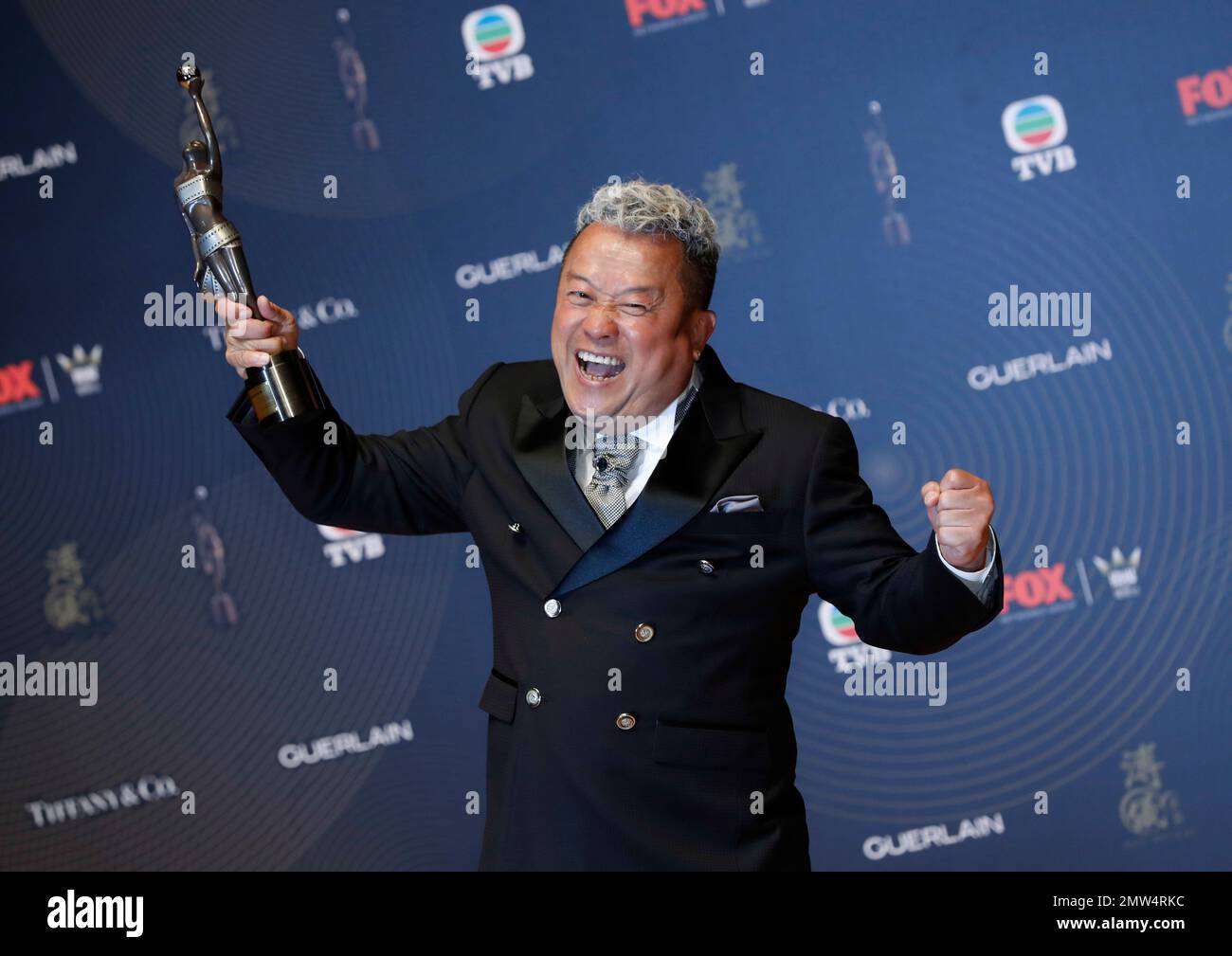 Hong Kong actor Eric Tsang poses after winning the Best Supporting ...