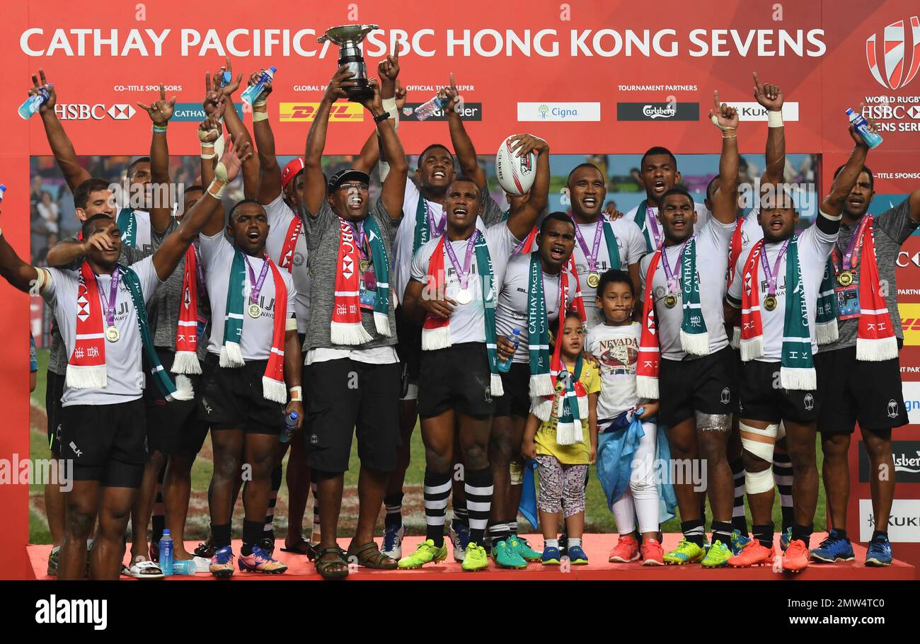 Fiji rugby team celebrate on the podium after winning the final match ...