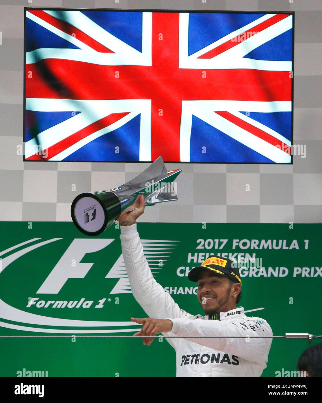 Mercedes driver Lewis Hamilton of Britain raises his trophy while ...