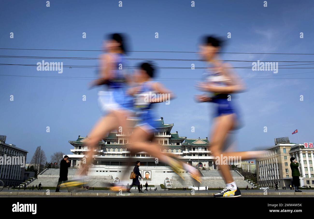Participants of the Pyongyang marathon run past the Kim Il Sung Square on Sunday, April 9, 2017 ...
