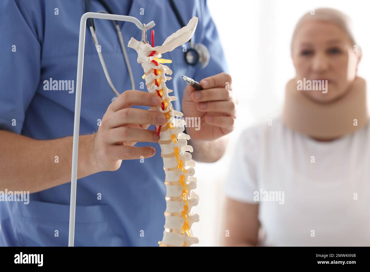Male doctor explaining spine patient hi-res stock photography and ...