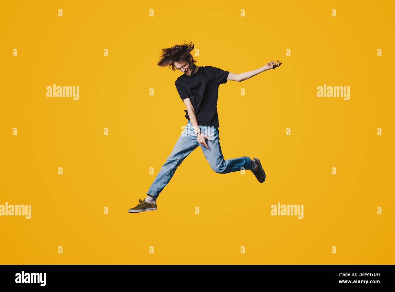 Full length photo of young handsome man jumping high up rejoicing ...