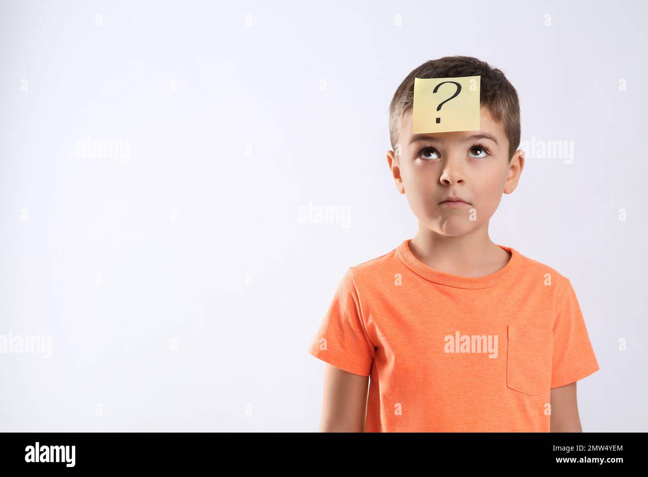 Emotional little boy with question mark on white background Stock Photo ...