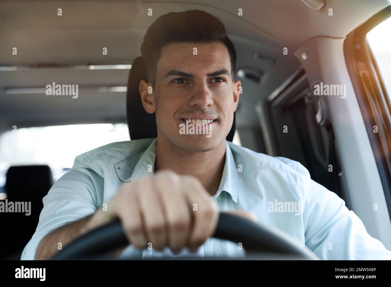 Handsome man driving his new modern car Stock Photo - Alamy