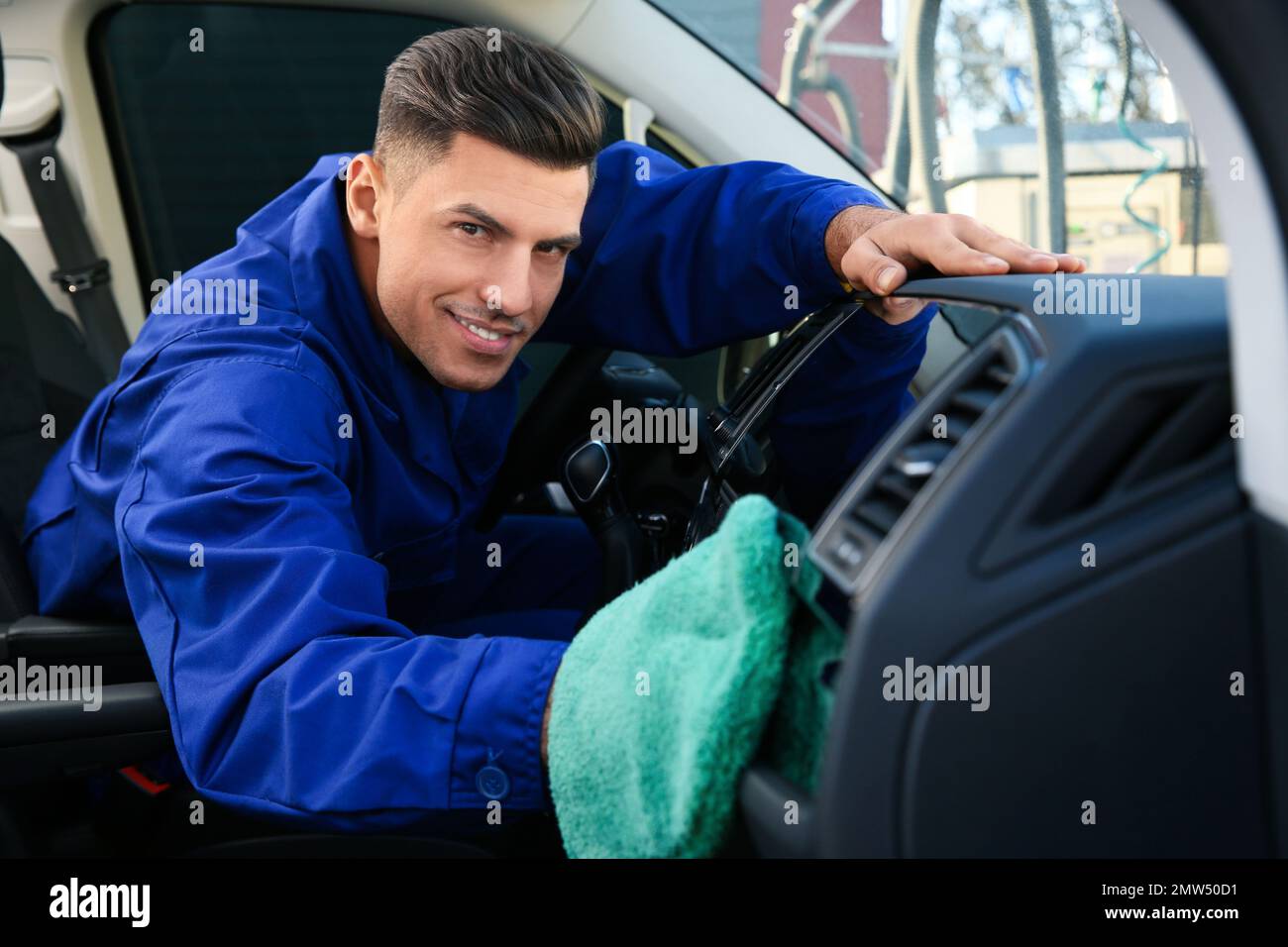 Car wash worker cleaning modern automobile interior Stock Photo - Alamy