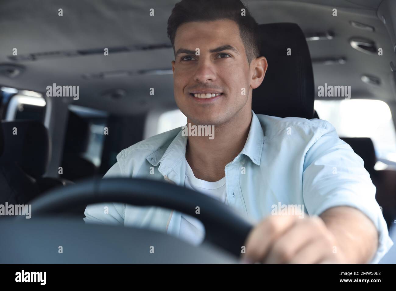 Handsome man driving his new modern car Stock Photo - Alamy
