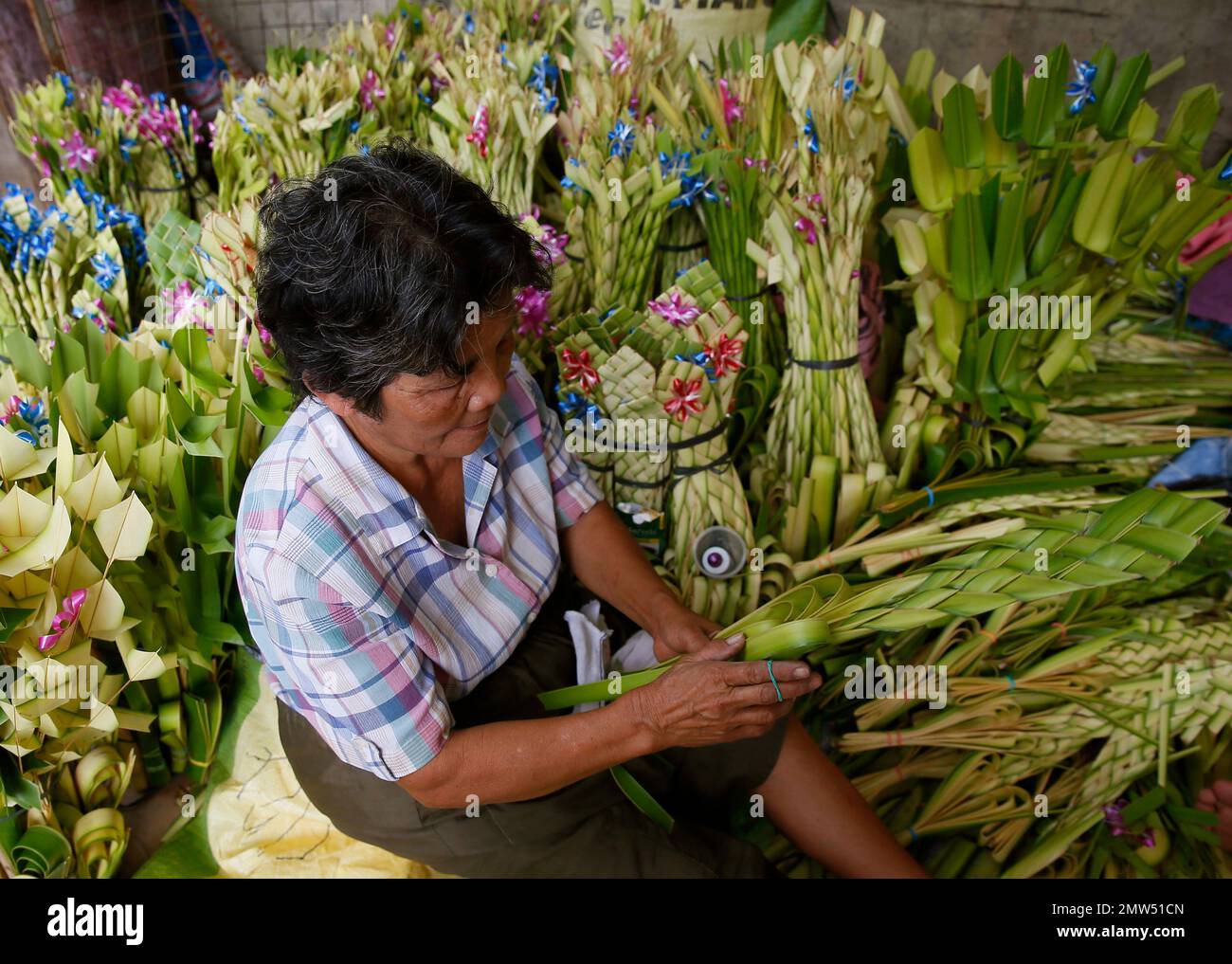 An enterprising resident makes different designs out of palm fronds as ...
