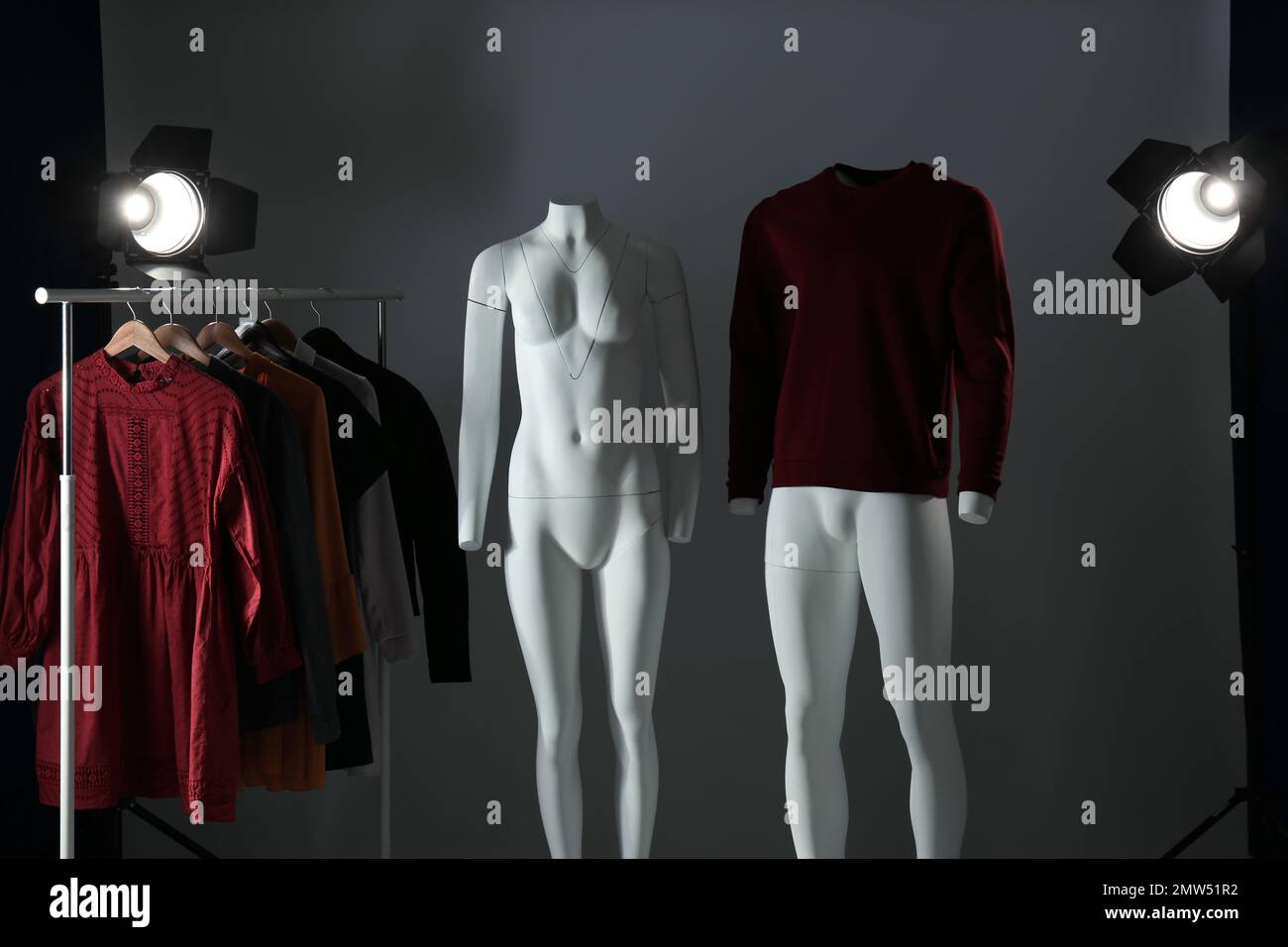 Ghost mannequins, clothes and professional lighting equipment in modern photo studio Stock Photo ...