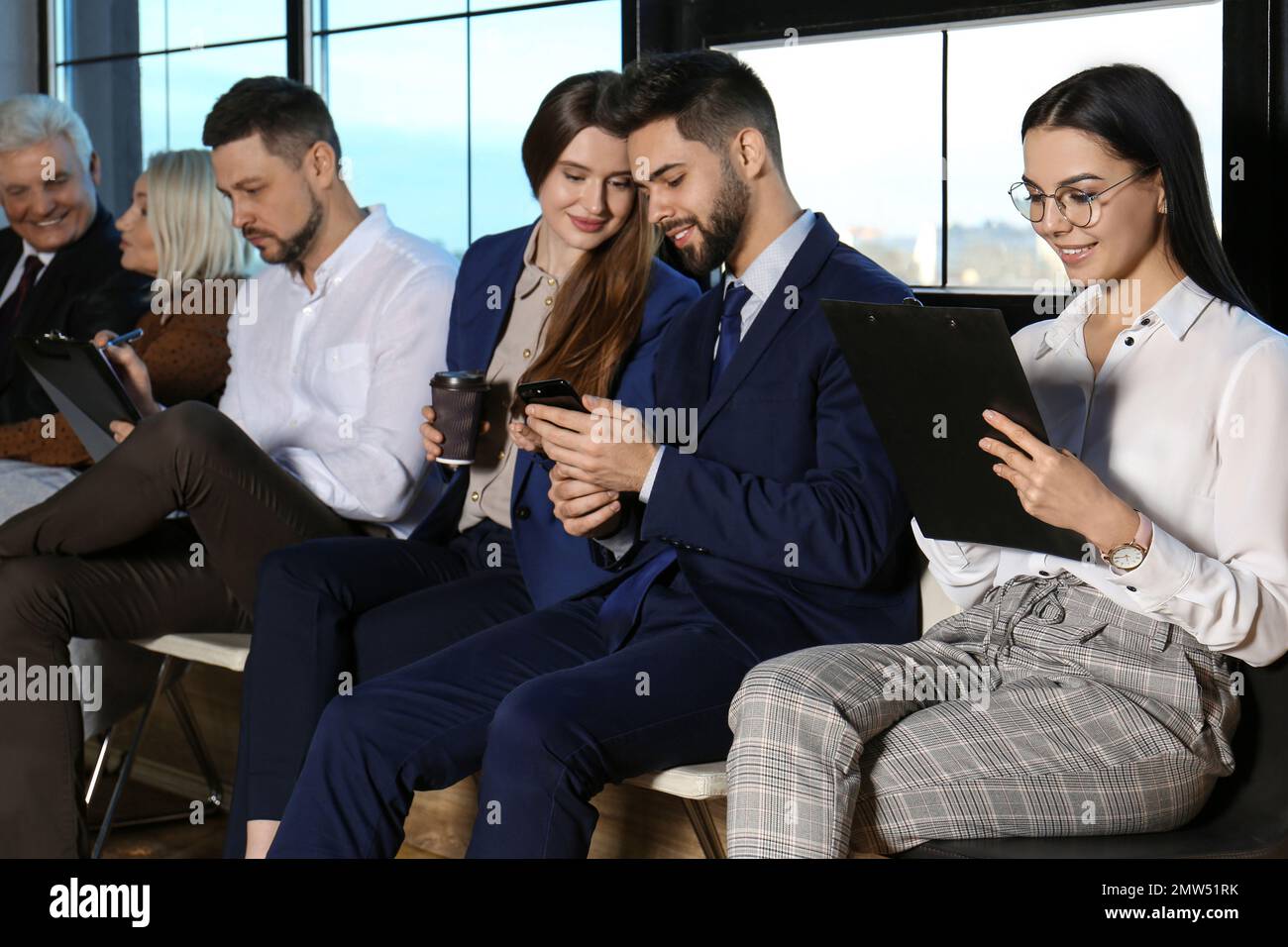 People waiting for job interview in office hall Stock Photo - Alamy