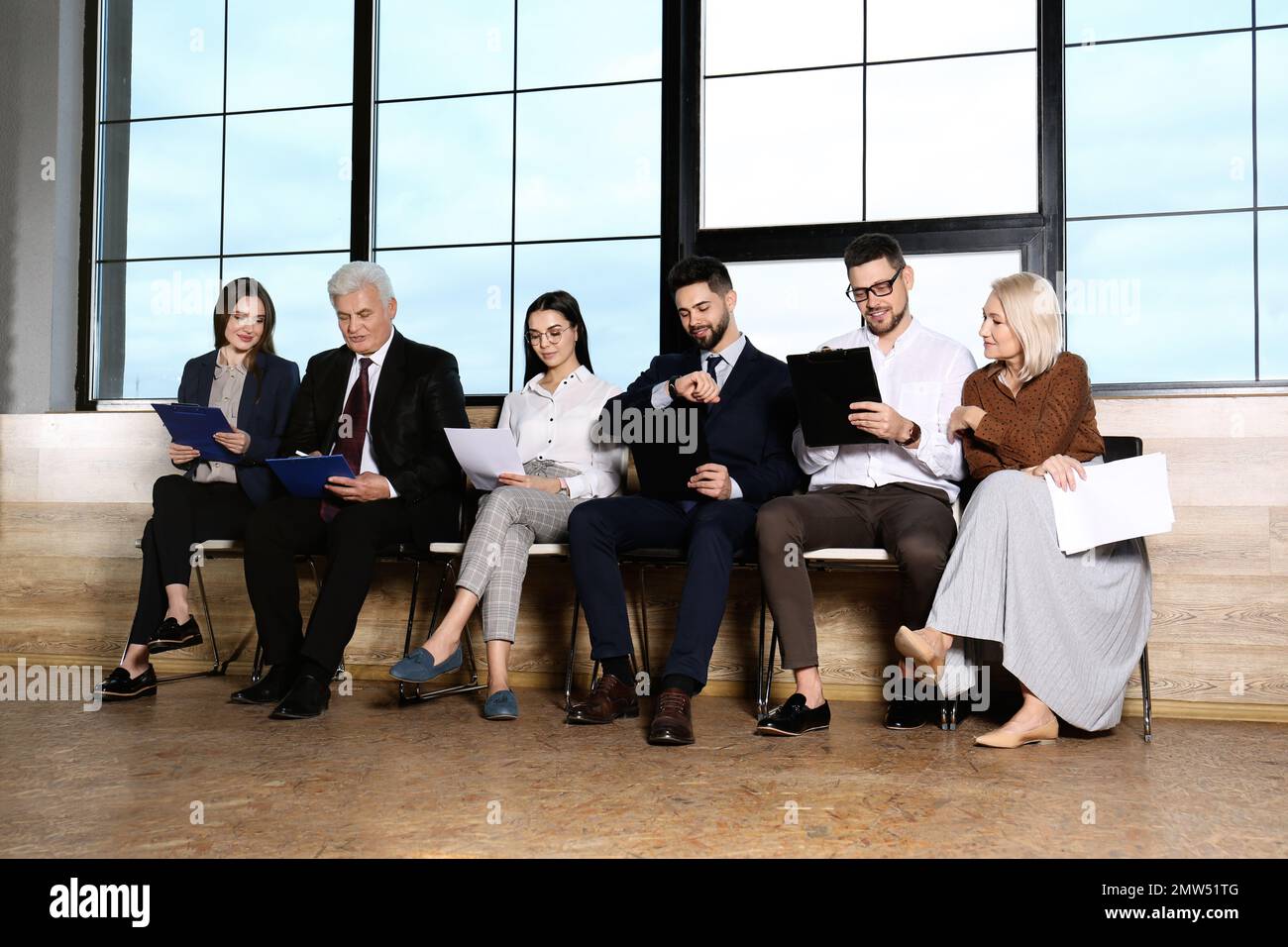 People waiting for job interview in office hall Stock Photo - Alamy