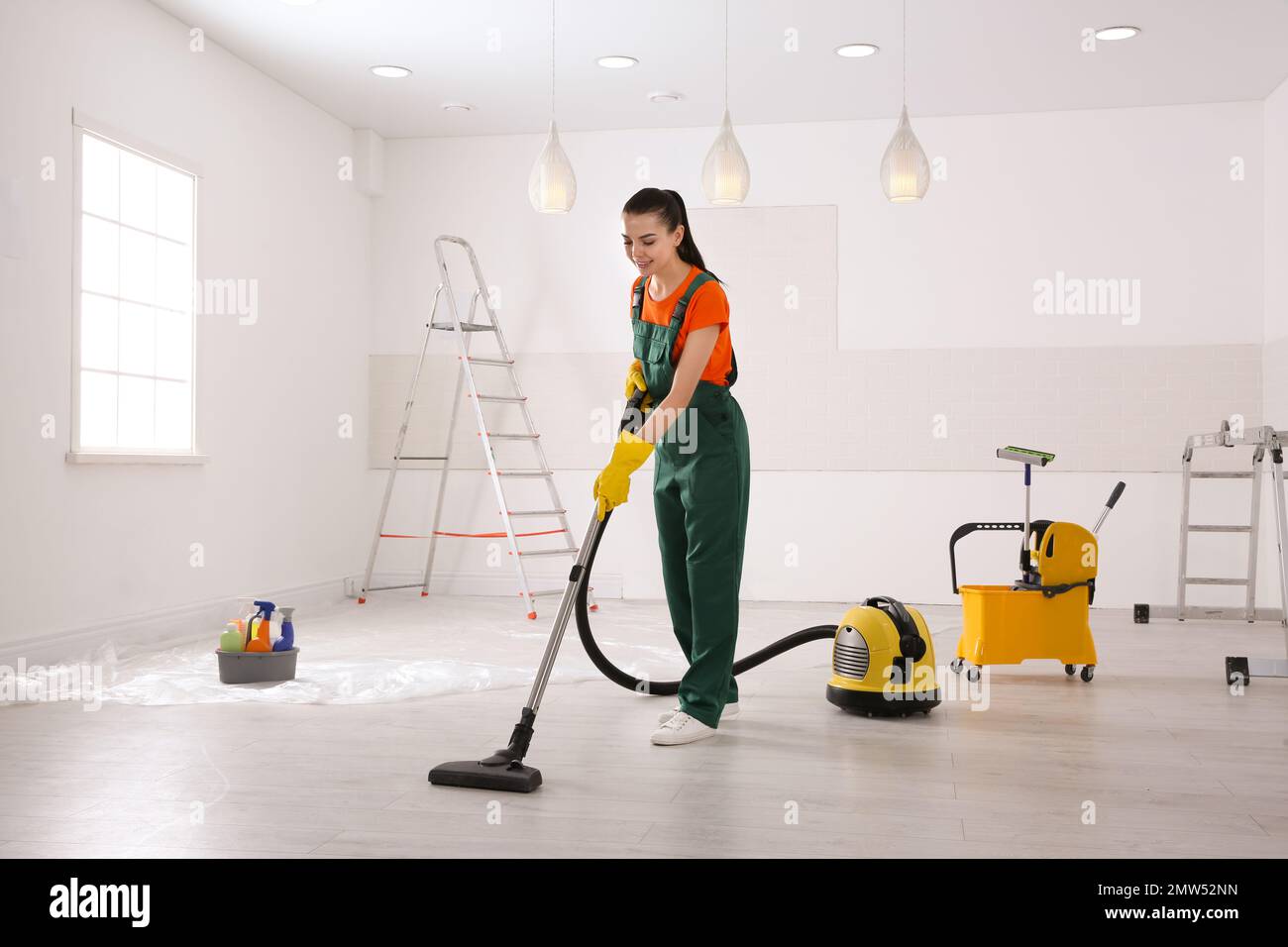 Professional janitor cleaning room with vacuum after renovation Stock ...