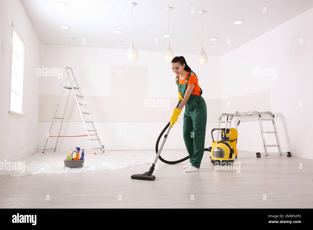 Professional janitor cleaning room with vacuum after renovation Stock ...