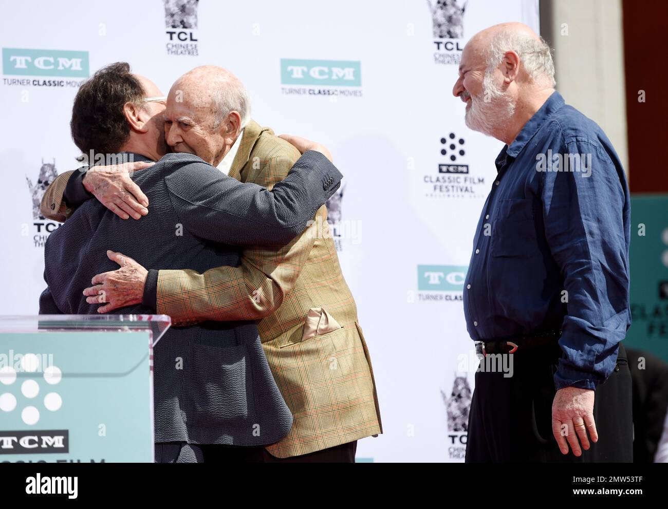 Guest speaker Billy Crystal, left, hugs Carl Reiner as Reiner's son Rob ...