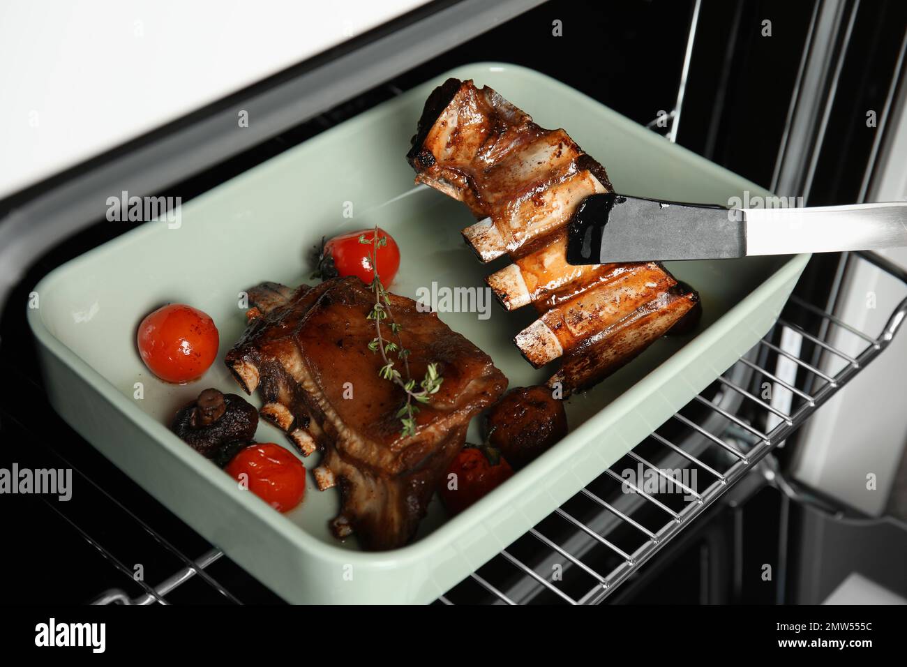 Delicious roasted ribs in oven. Yummy meat Stock Photo - Alamy
