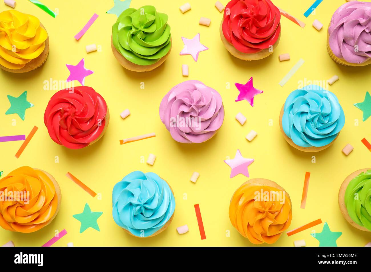 Colorful birthday cupcakes on yellow background, flat lay Stock Photo ...