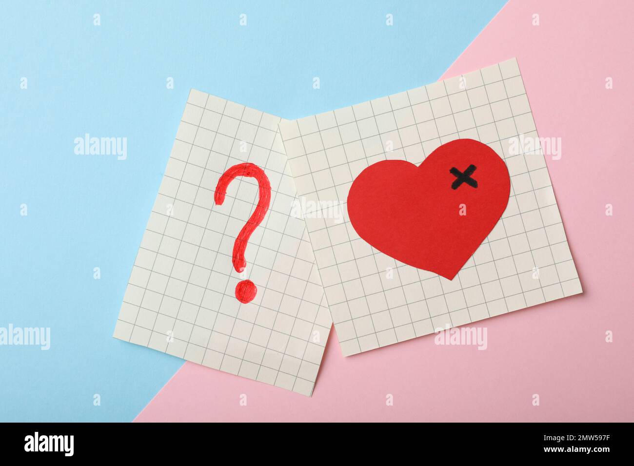 Paper notes with drawings of heart and question mark on color ...