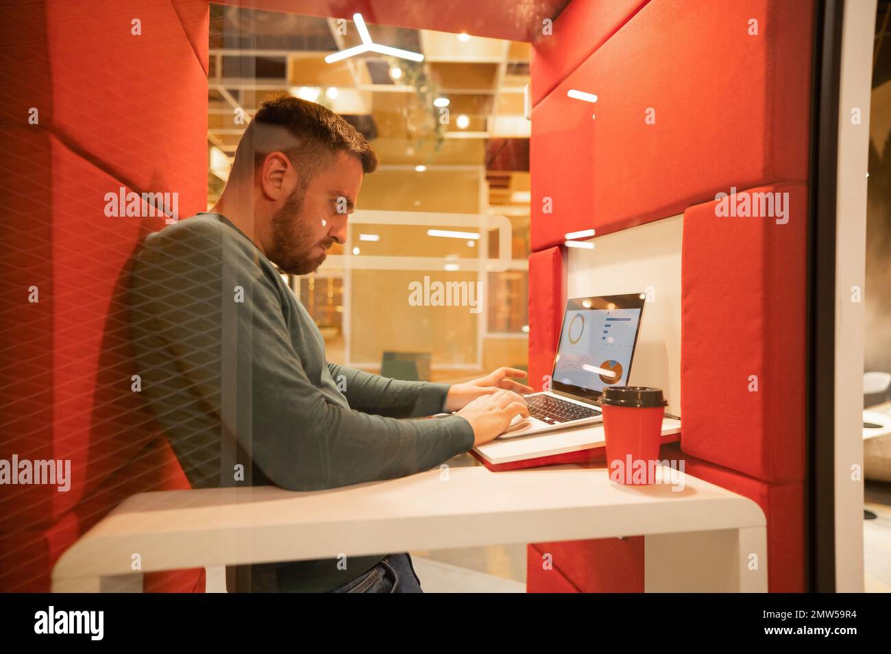 A bearded man in a booth for online negotiations. Privacy booth Stock ...