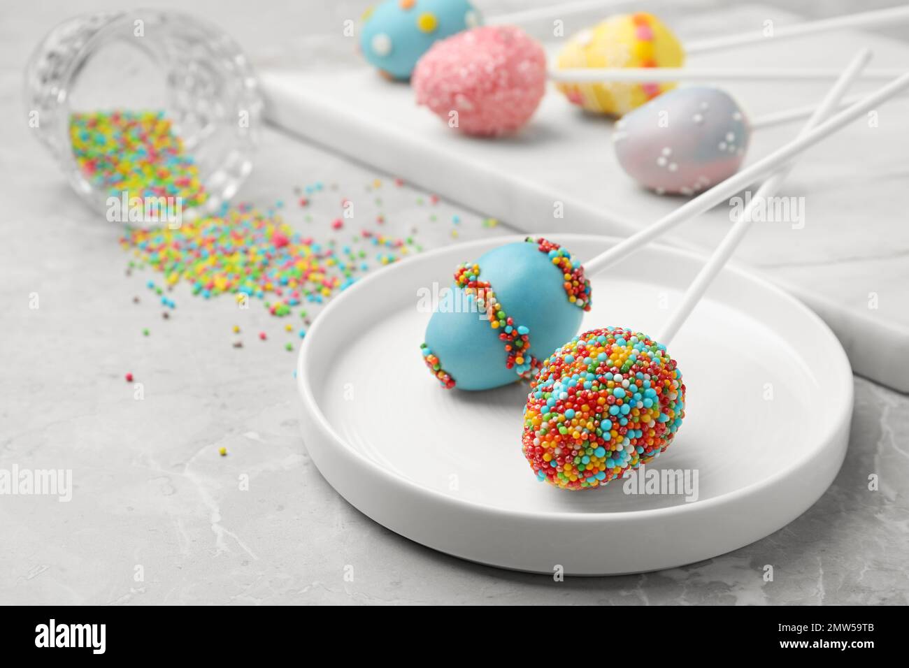 Egg shaped cake pops for Easter celebration on grey marble table Stock ...