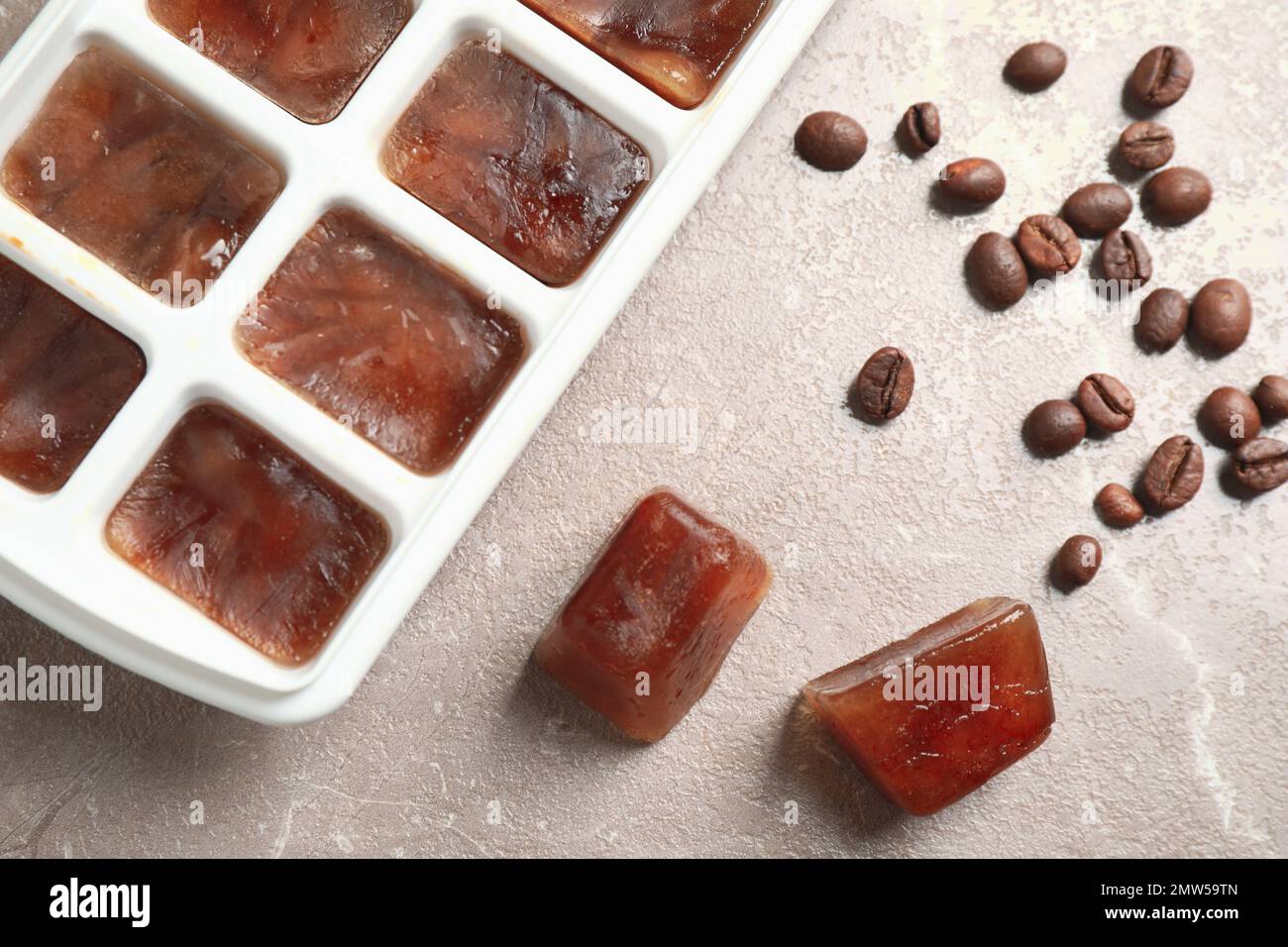 Ice cubes and coffee beans on grey table, flat lay Stock Photo - Alamy