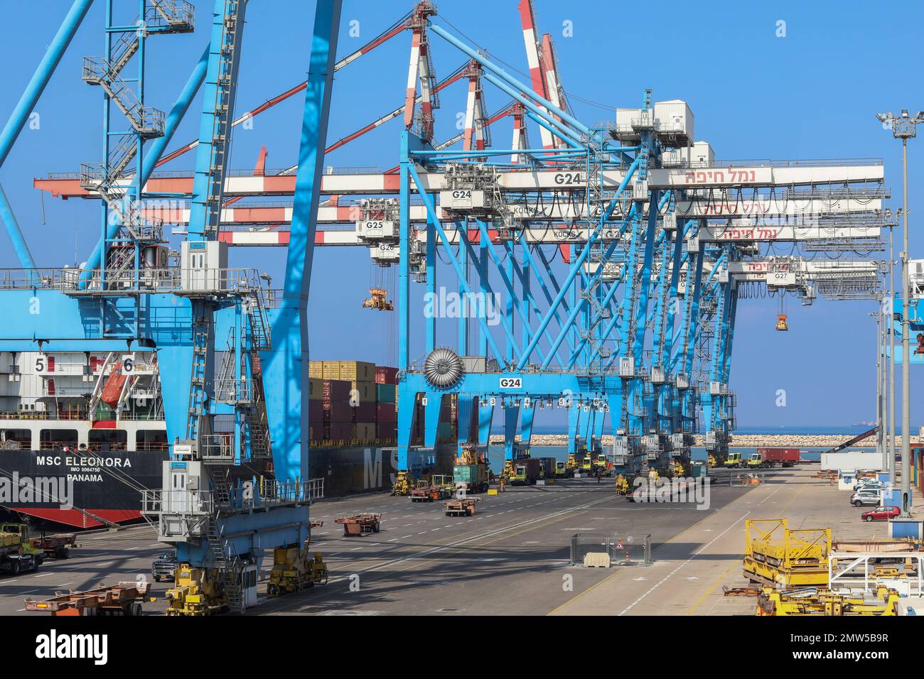 Haifa, Israel - October 11, 2021: Crane activity in the port. Container terminal during loading ...