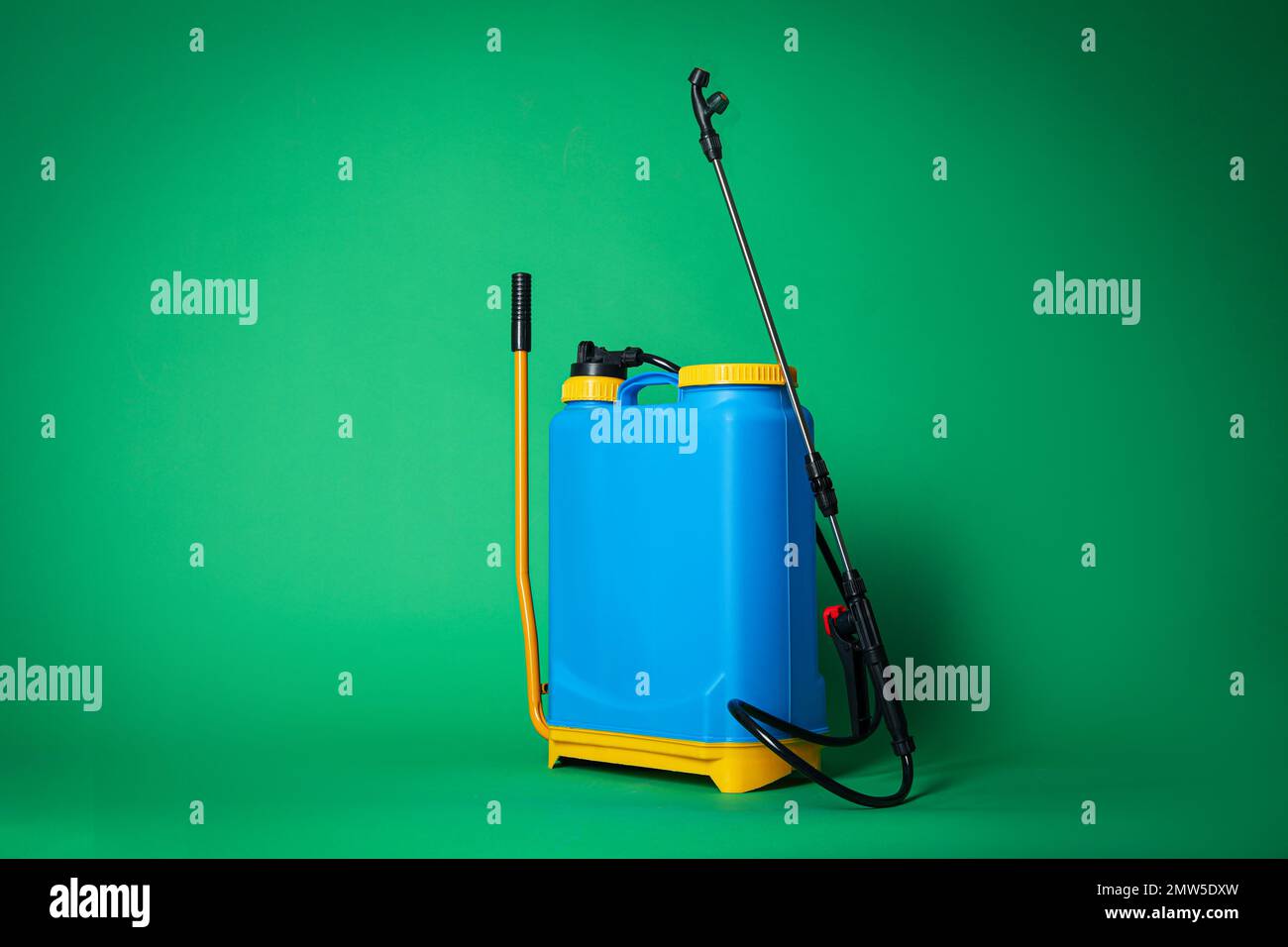 Manual insecticide sprayer on green background. Pest control Stock ...