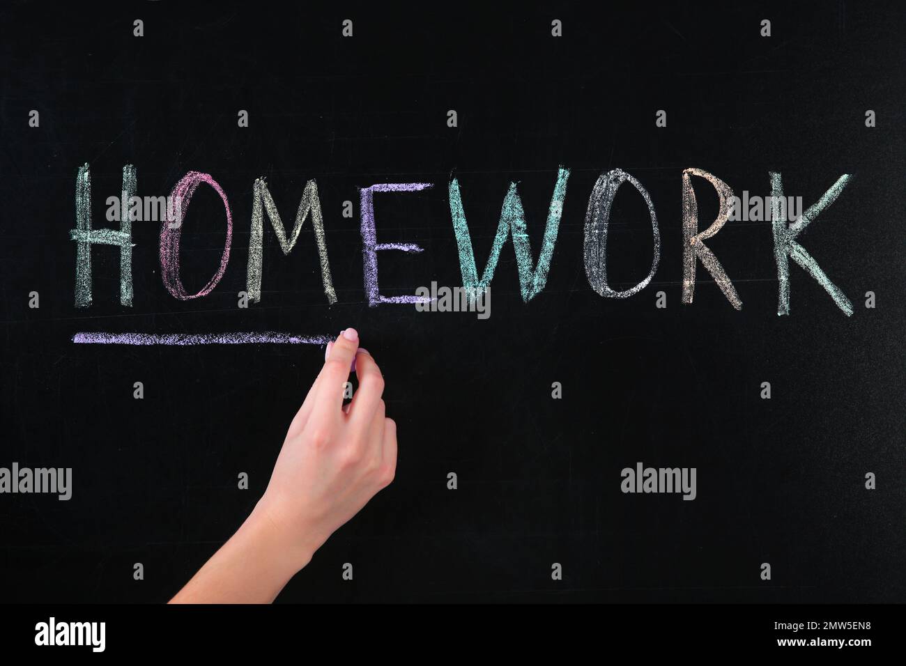 Woman writing word homework hi-res stock photography and images - Alamy