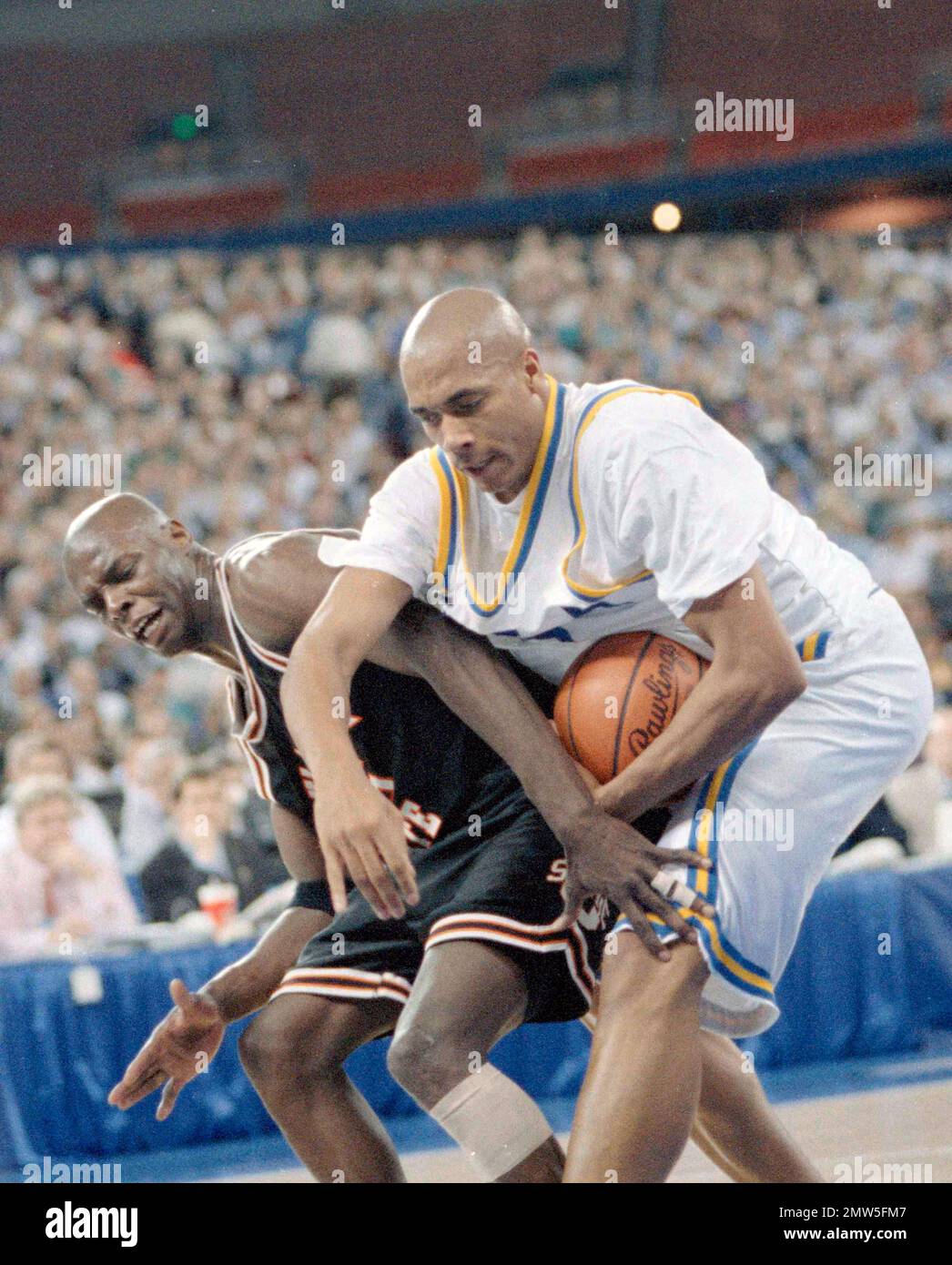 UCLA's Charles O'Bannon and Oklahoma State's Randy Rutherford go for a ...