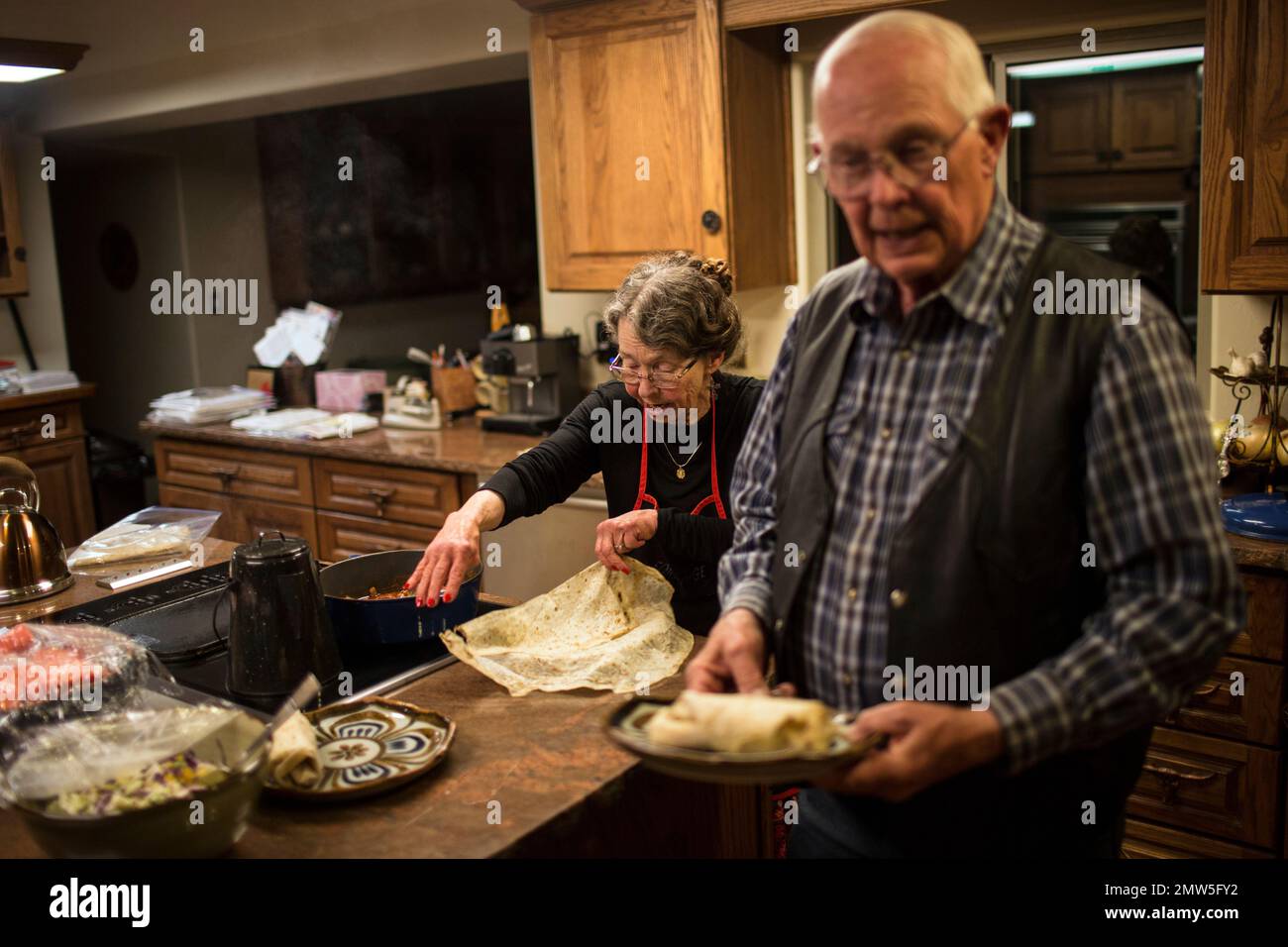 Rancher Jim Chilton prepares dinner with his wife Sue, inside the home ...