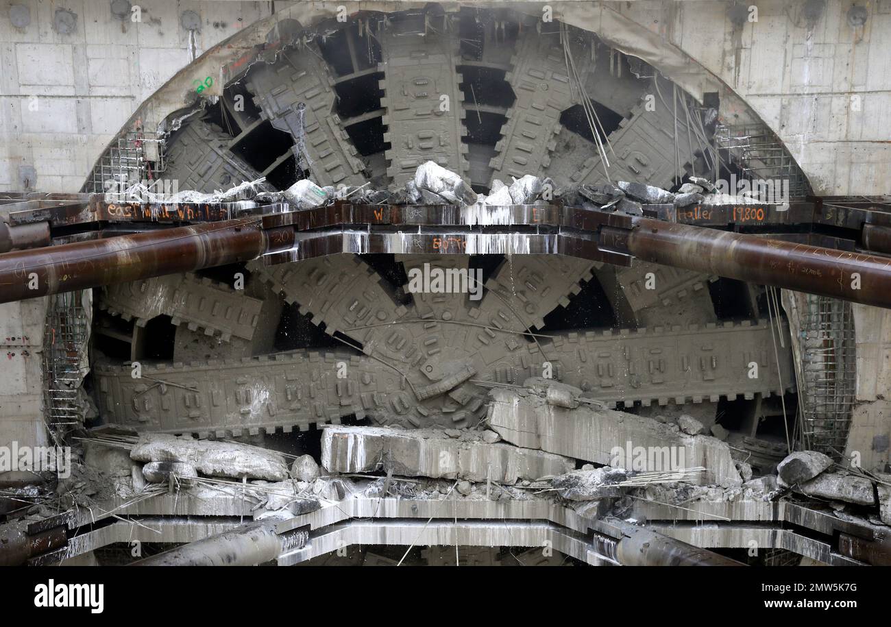 A massive tunneling machine breaks through a five-foot wide concrete ...