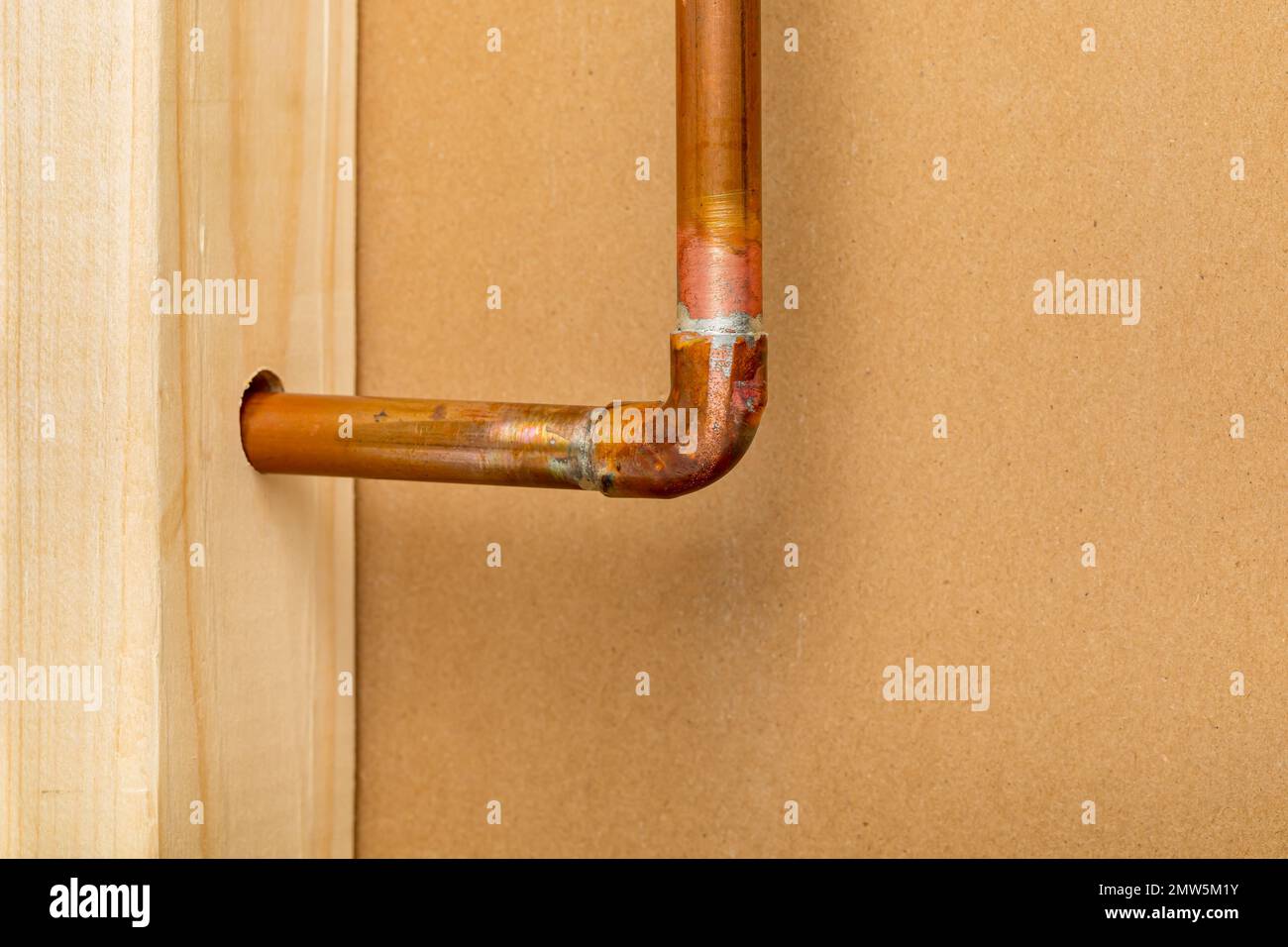 Copper water plumbing pipe inside wall. Home repair, maintenance and ...