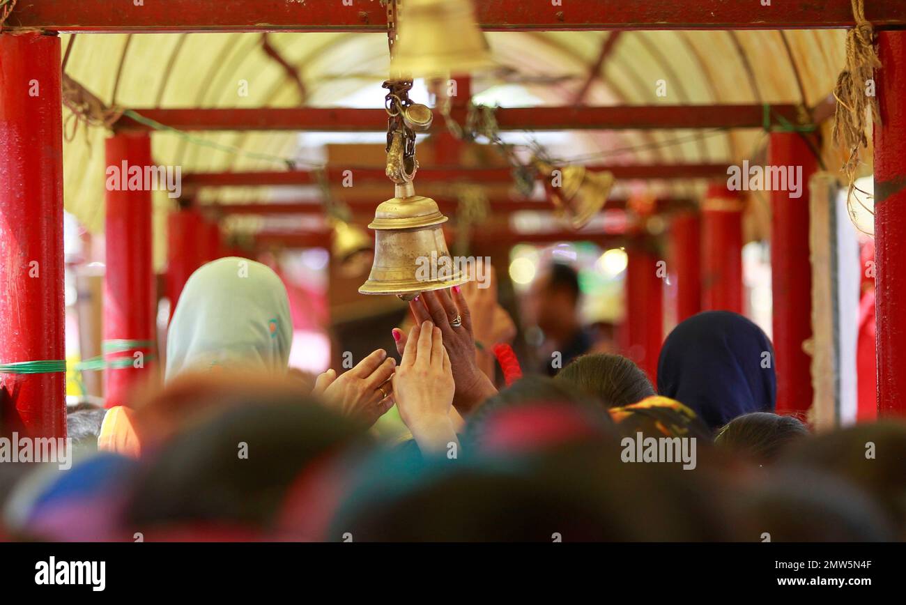 Hindu devotees ring a bell inside the Kali Temple during Navratri ...