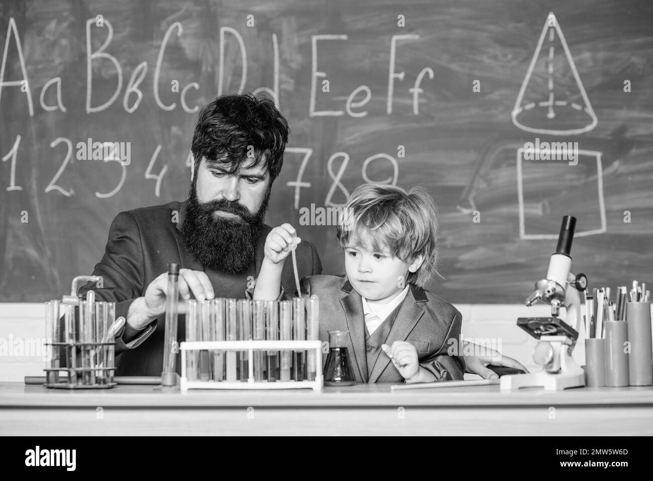 Inspiration Technology. father and son at school. teacher man with ...