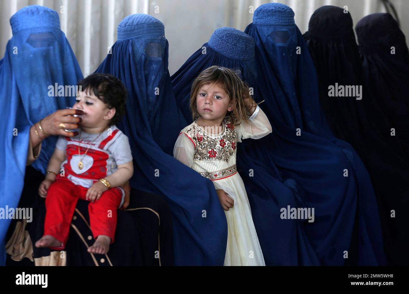 Afghan refugees wait for a transport at the UNHCR's Repatriation Center ...